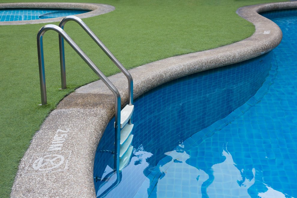 Should I install artificial turf around my swimming pool?